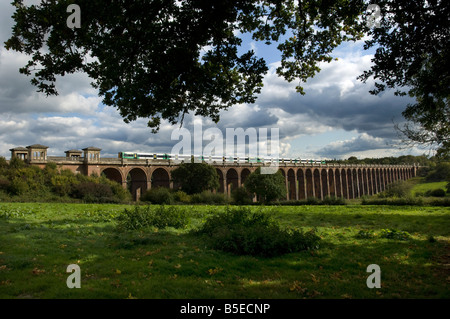 A Southern Rail commuter express train crosses the Ouse Valley Viaduct ...
