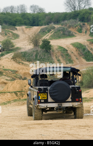 Rear view of a Land Rover defender driving off road in the UK Stock ...