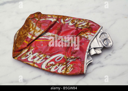 Old rusty Coca-Cola can with a purple flower inside with a black ...