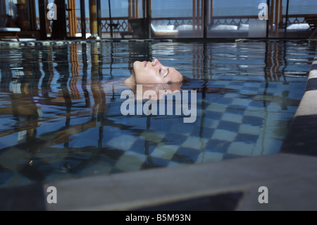 Woman floating face up in sea water, very relaxed. Formentera island ...