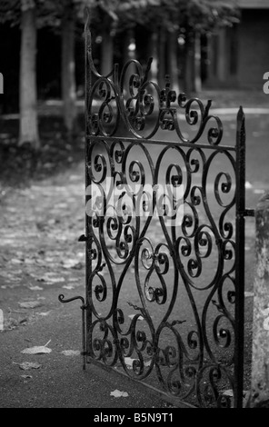 A half-open wrought iron gate in Vigeland Sculpture Park invites to ...