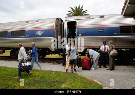 Amtrak railroad conductors assisting passengers onto train DeLand Train ...