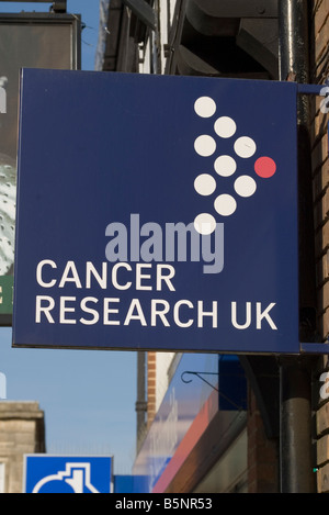 A Cancer Research Charity shop with donations left in black bags ...
