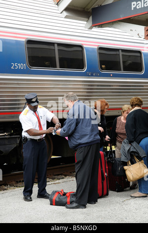 Amtrak railroad conductor alights passenger train railroad America USA ...