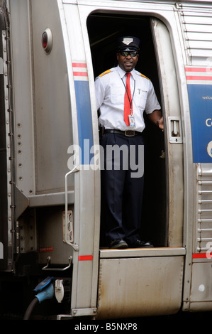 Amtrak railroad conductor alights passenger train railroad America USA ...