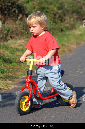 Toddler learning how to ride her first bike Stock Photo - Alamy