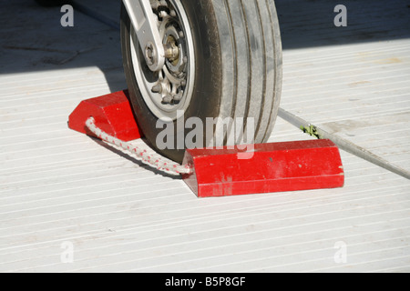 detail of red chocks blocks on fighter jet wheels at open day event ...