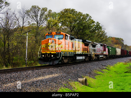 Diesel locomotive train pulling box cars on a railroad track Stock ...