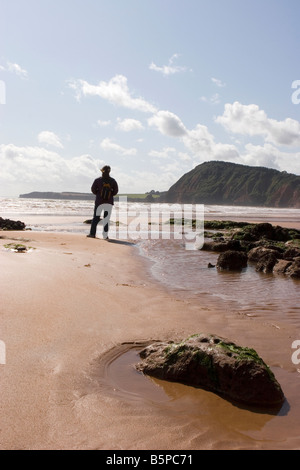 A woman at the beach looking out over the ocean Stock Photo - Alamy