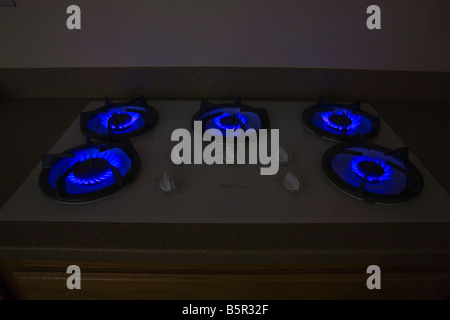 Lit natural gas stove burners on cooktop Stock Photo - Alamy