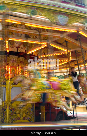 Merry-go-round in motion Stock Photo - Alamy