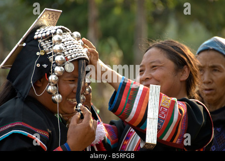 Akha hill tribe woman getting dressed in her traditional costume in a ...
