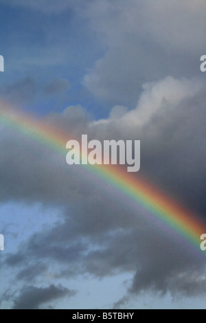 one colourful rainbow arch curve and dark sky Stock Photo - Alamy