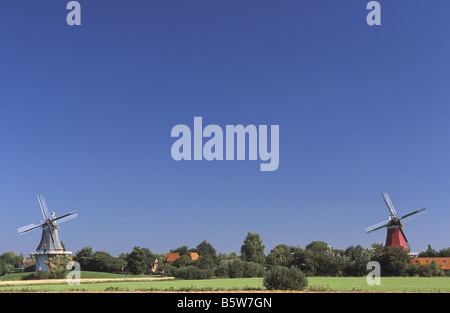 two windmills between trees Stock Photo - Alamy