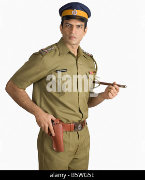 Portrait of a policeman holding a handgun Stock Photo - Alamy