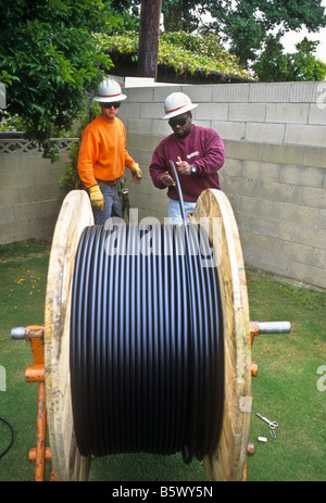 Electricity utility workers maintain power distribution lines in ...