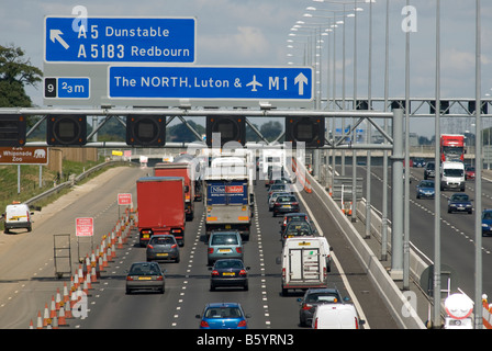 Traffic driving along the M1 motorway with matrix system displaying ...