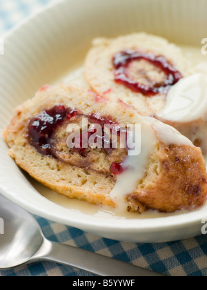 Hot jam roly poly and custard dessert Stock Photo - Alamy