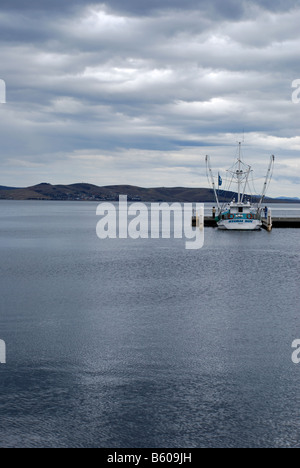 Lone Boat Moored on a Calm Blue Fjord, Puyuhuapi, Chile Stock Photo - Alamy