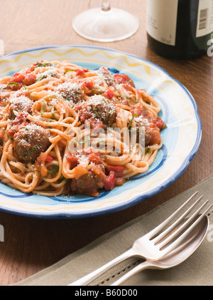 Pasta spaghetti with meatballs and tomato sauce on a white plate on a ...