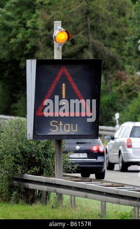 German road sign traffic jam and public transport with blue sky and ...