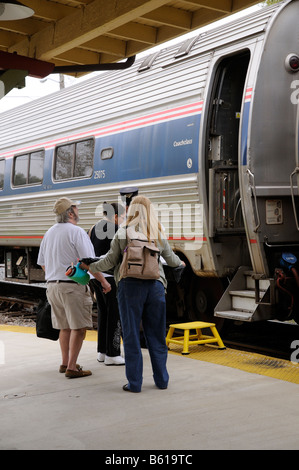 Amtrak railroad conductors assisting passengers onto train America USA ...