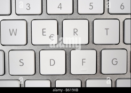Keyboard of an Apple MacBook Pro Notebook, finger pointing to the EURO ...