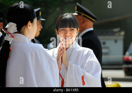 Shinto temple servants or shrine maidens, called Mikos, in traditional ...