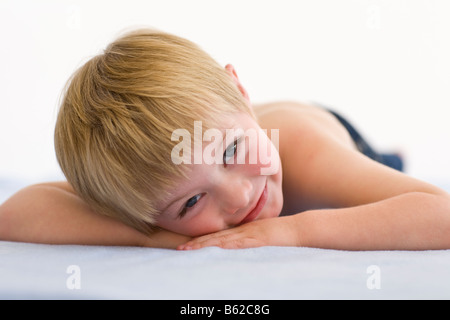 little boy laying on floor smiling, head on arms Stock Photo: 20994856 ...