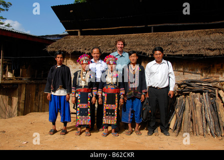 Man and woman of the Akha Lom ethnic group wearing colorful traditional ...