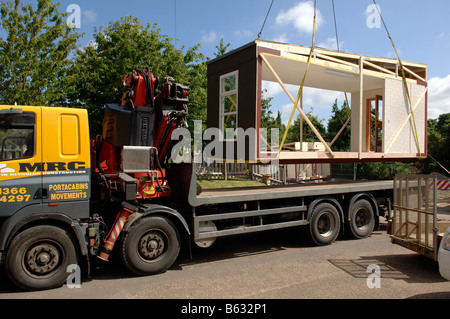 Lifting modular building section off back of a lorry by crane Stock ...