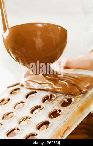 Caramel being poured on a delicious frappuccino with whipped cream in a ...