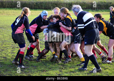 Teenage girls playing Rugby on a cold wet autumn afternoon Stock Photo ...