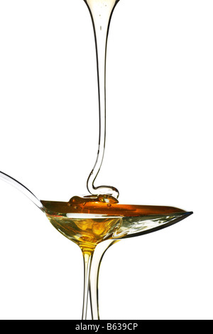 Golden syrup or treacle dripping Stock Photo - Alamy