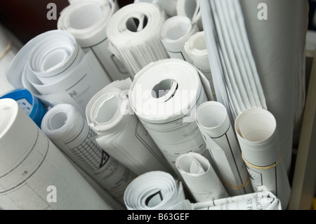 Rolls of building plans drawing designs Stock Photo - Alamy