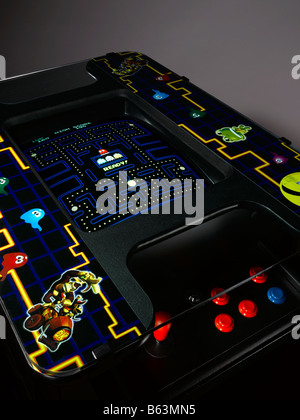 A retro Atari video game console resting atop a wooden surface Stock ...