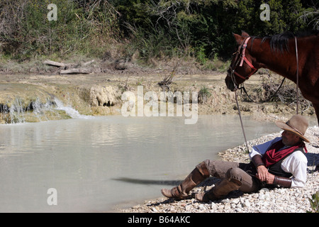 A cowboy and horse resting by a stream in the old West Stock Photo - Alamy