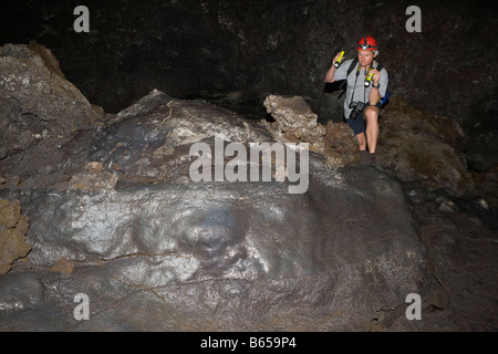 Tourist in biggest Portugese Volcanic Cave Gruta das Torres Pico Island ...