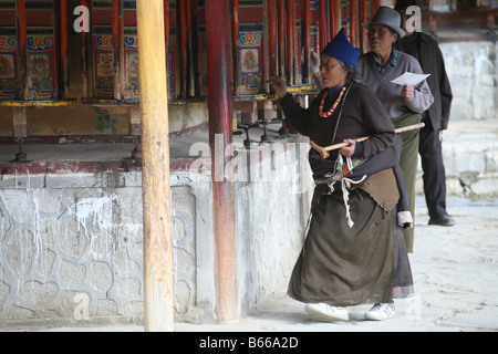 Two ethnic Chinese men praying in front of ornately decorated Sri ...