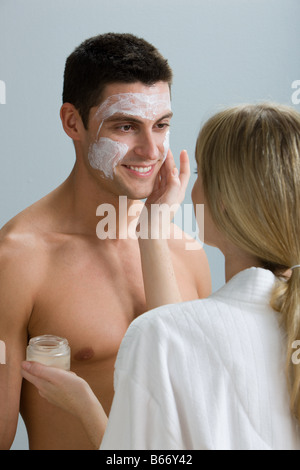 Woman Applying Face Mask Stock Photo - Alamy