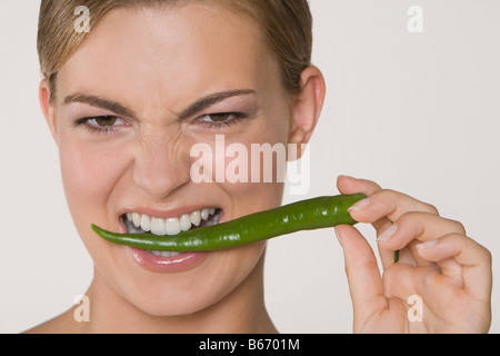 woman biting a chilli Stock Photo - Alamy