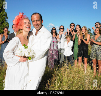 happy middle aged groom hugging cheerful bride in wedding dress ...