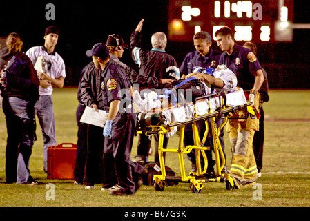 Paramedics carrying an injured football player on a stretcher Stock ...