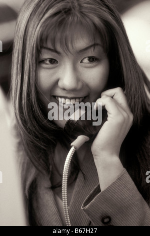 Young Woman Using A Payphone Stock Photo - Alamy