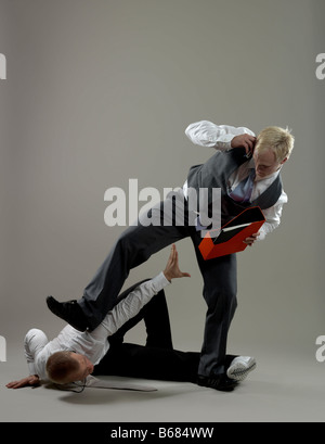 Full length of angry businessman kicking against white background Stock ...
