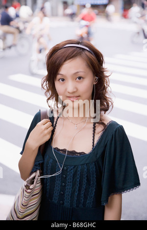 Young chinese woman wearing striped t-shirt and denim shirt over ...