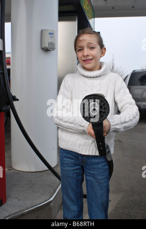 Kid pumping gas Stock Photo - Alamy
