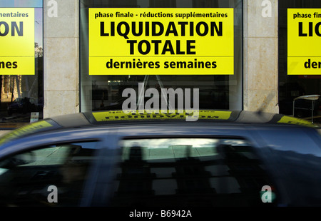 Total liquidation sale signs in storefront windows of a closed retail ...