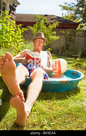Man reading a book while floating in ocean Stock Photo - Alamy
