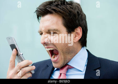 Angry man screaming at his phone Stock Photo - Alamy